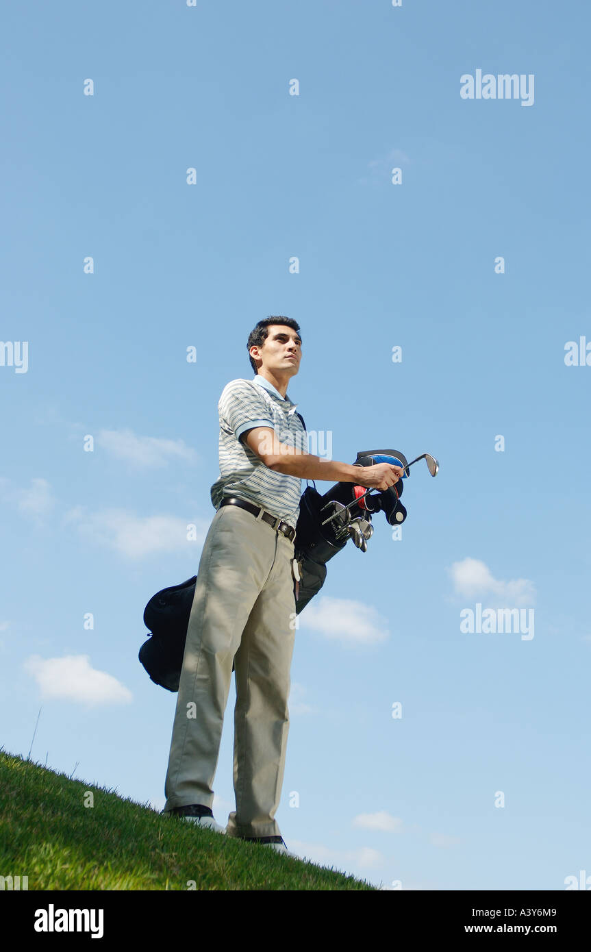 Man carrying golf clubs hi-res stock photography and images - Alamy