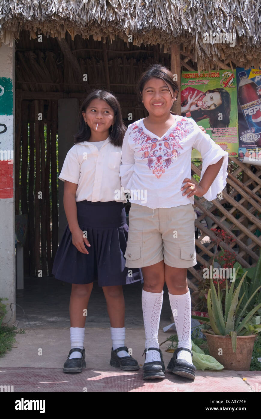 Portrait reportage news two young school girls posing in front of store ...
