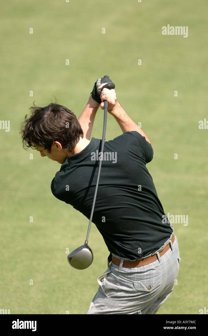 Rear view of a male golfer playing a shot Stock Photo - Alamy