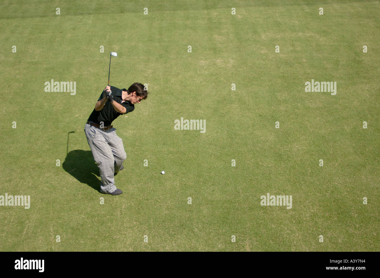 Side view of a male golfer playing a shot Stock Photo - Alamy