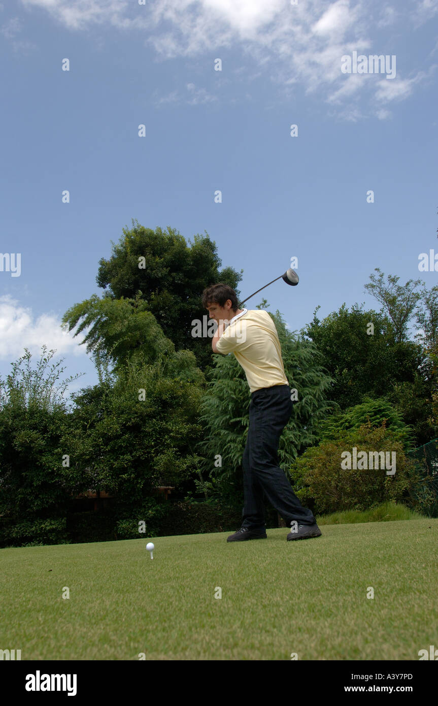 Side view of a man playing a golf shot Stock Photo - Alamy