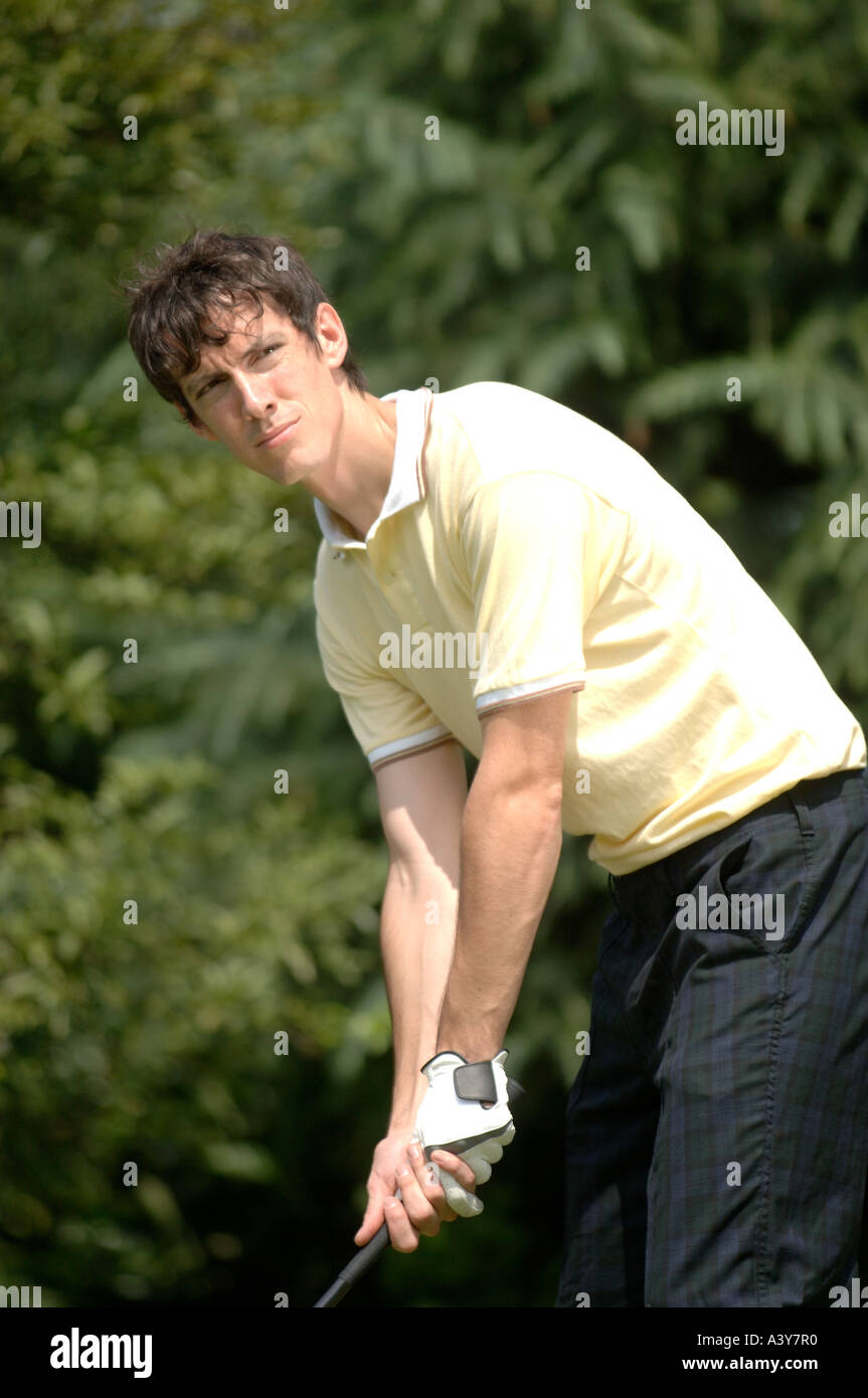Side view of a man playing a golf shot Stock Photo - Alamy