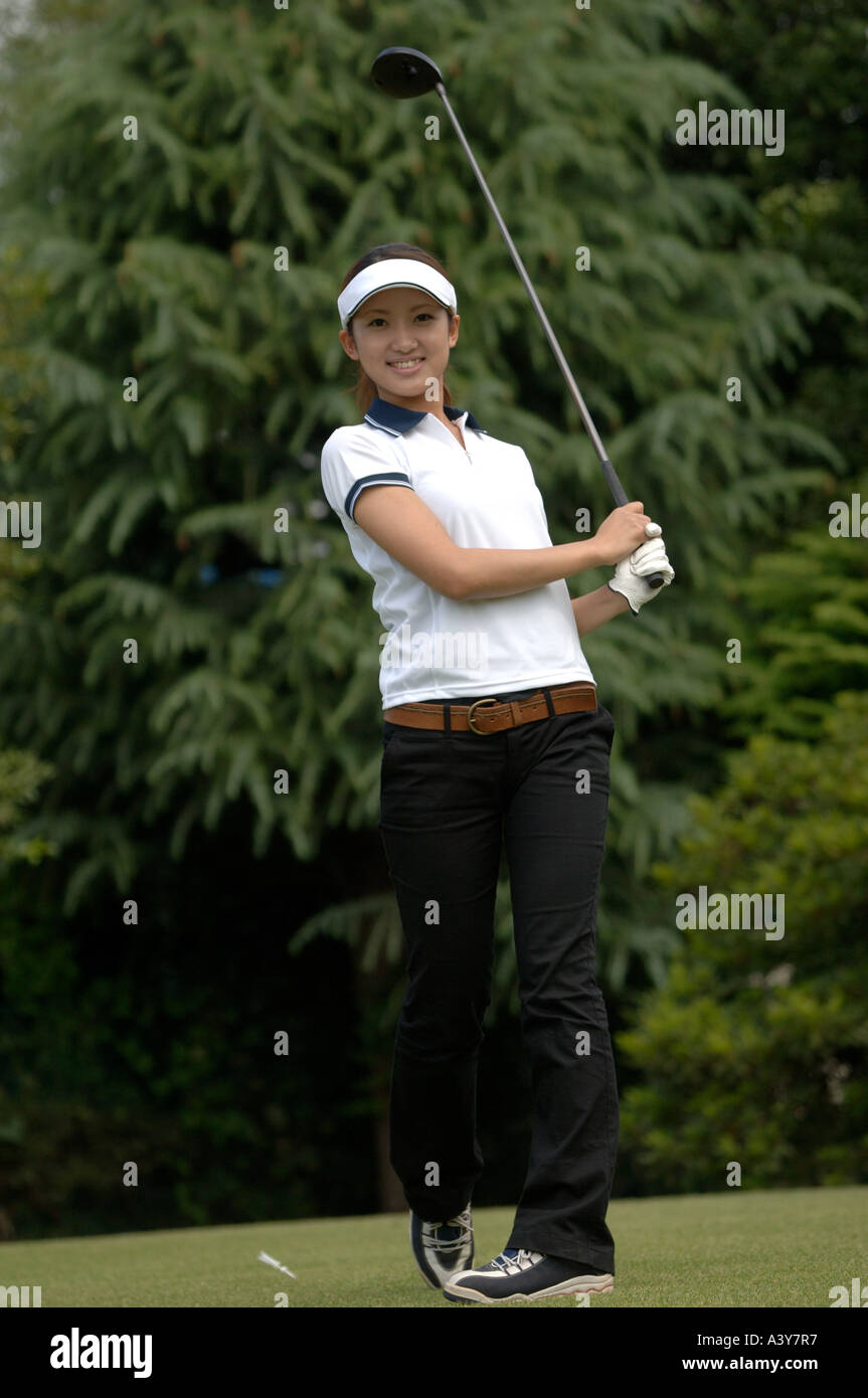 Front view of a woman playing a golf stroke Stock Photo - Alamy