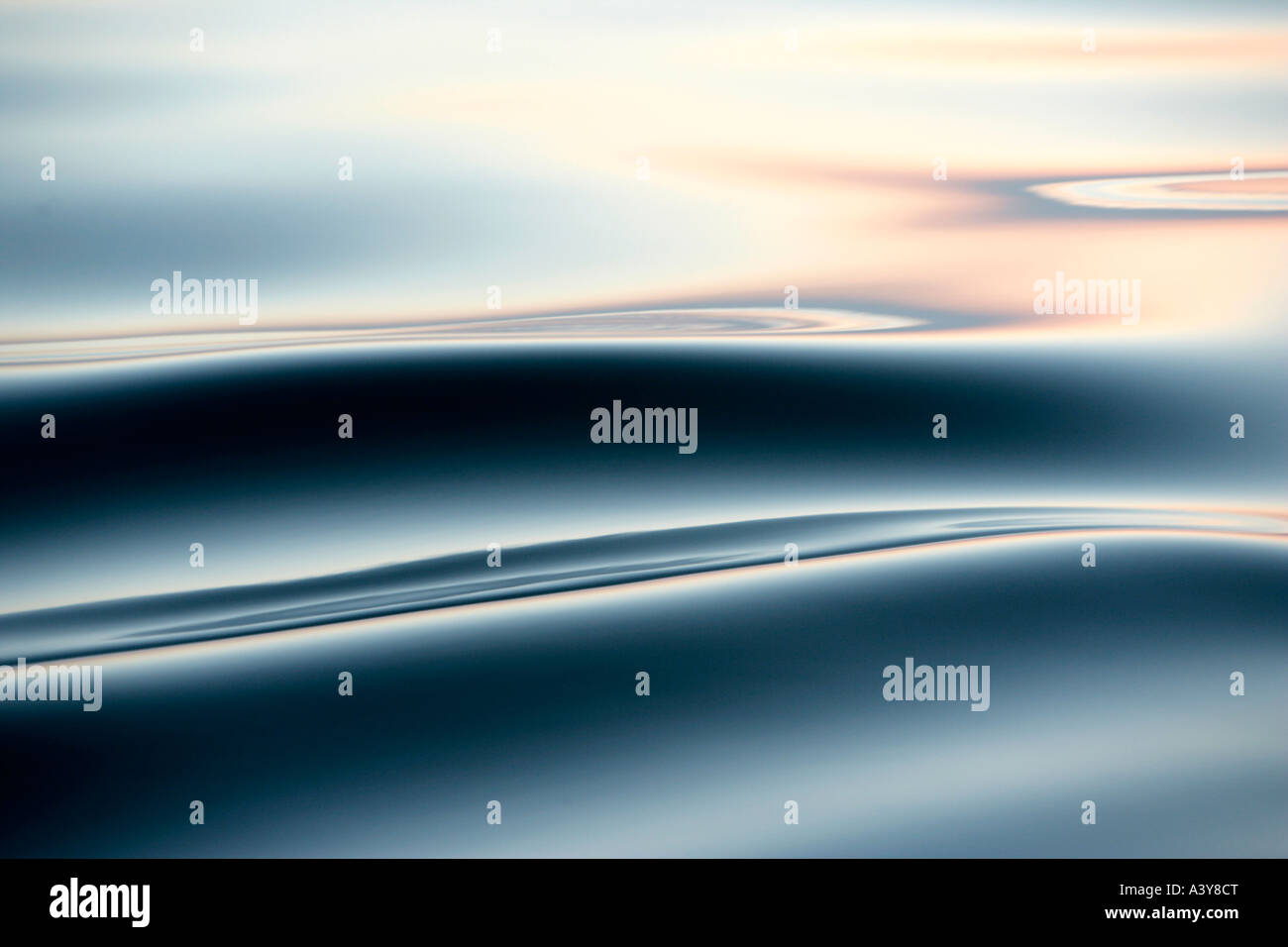 Colourful reflections in a calm sea surface Stock Photo - Alamy