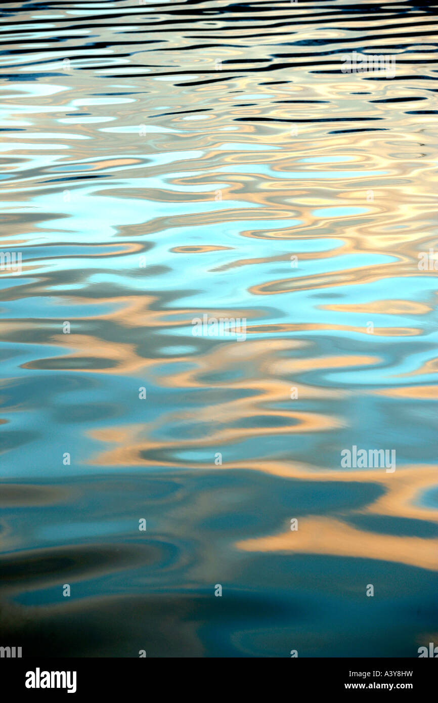 Colourful reflections in a calm sea surface Stock Photo - Alamy