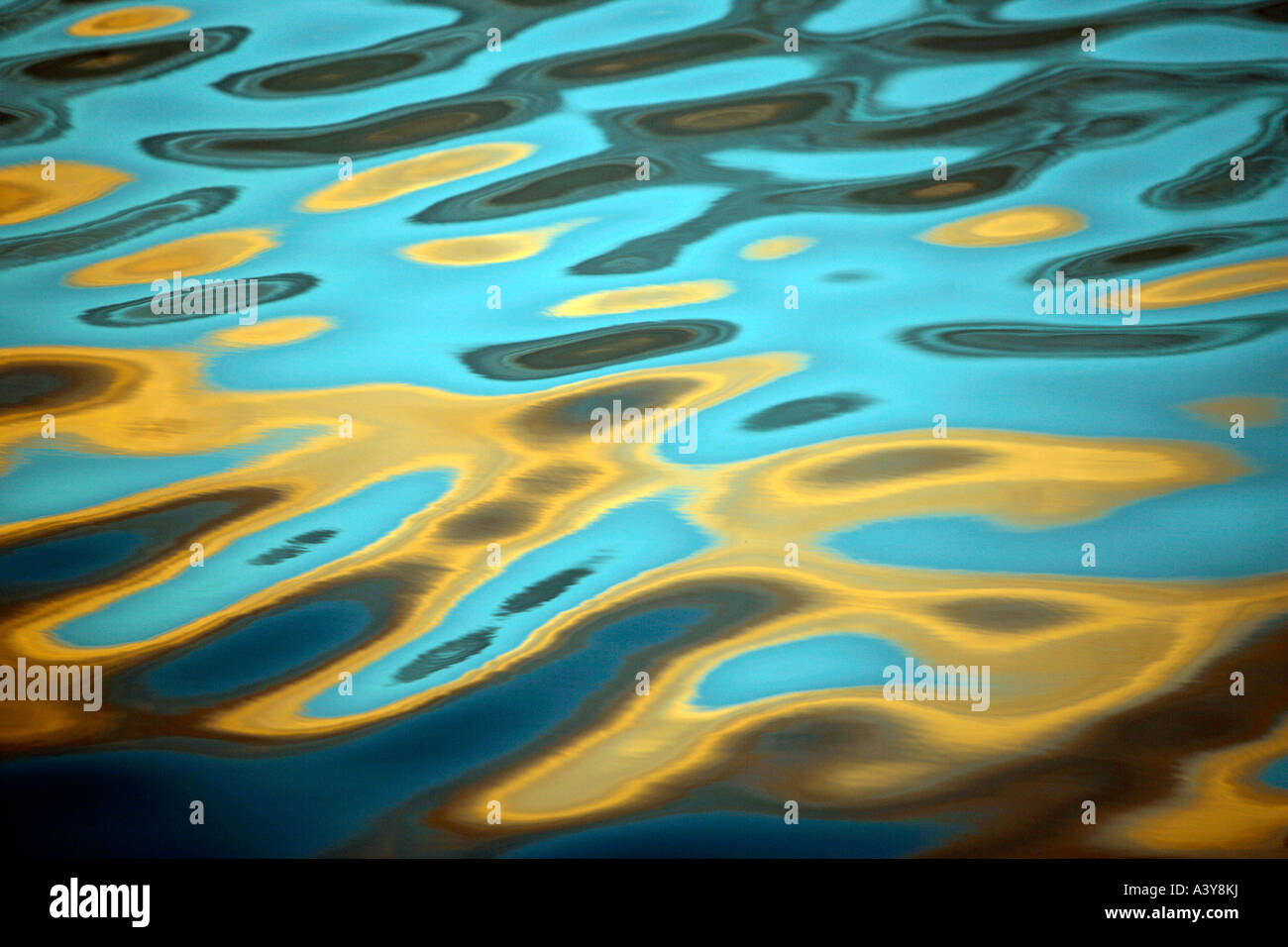 Colourful reflections in a calm sea surface Stock Photo - Alamy