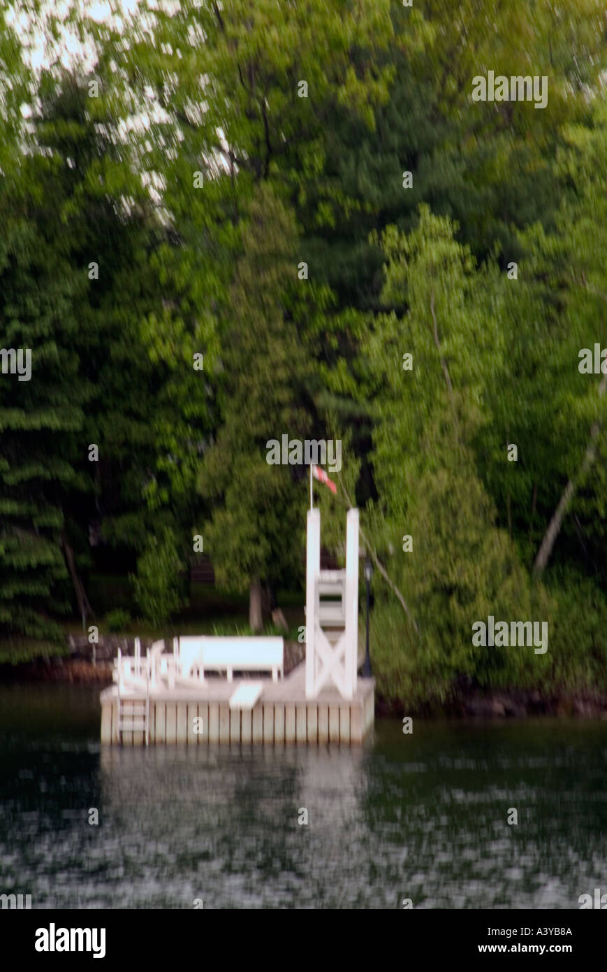 Floating wooden platform on lake trees background. Thousand Islands ...