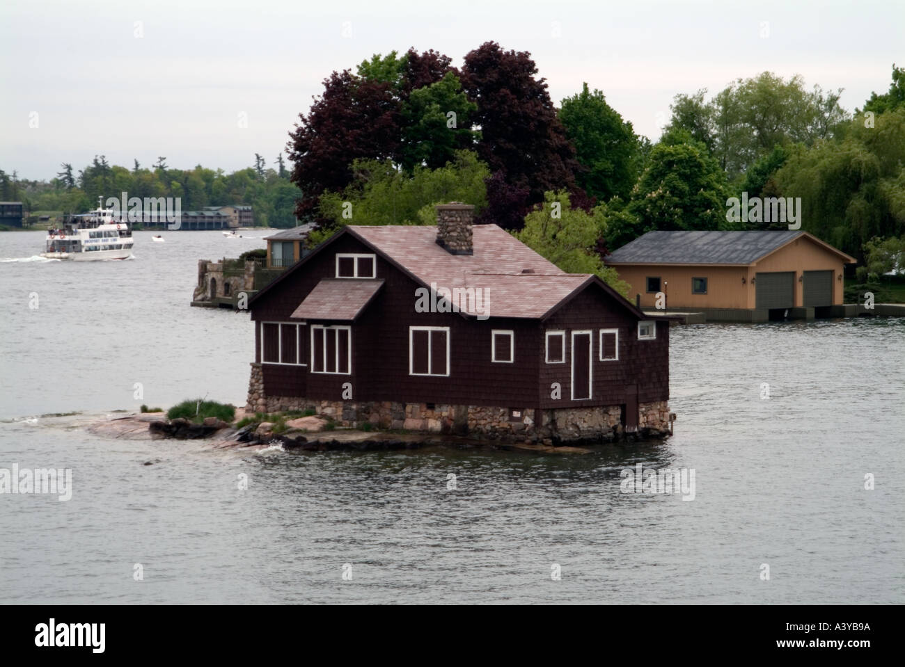 House on island tour boat trees background. Thousand Islands Canada ...