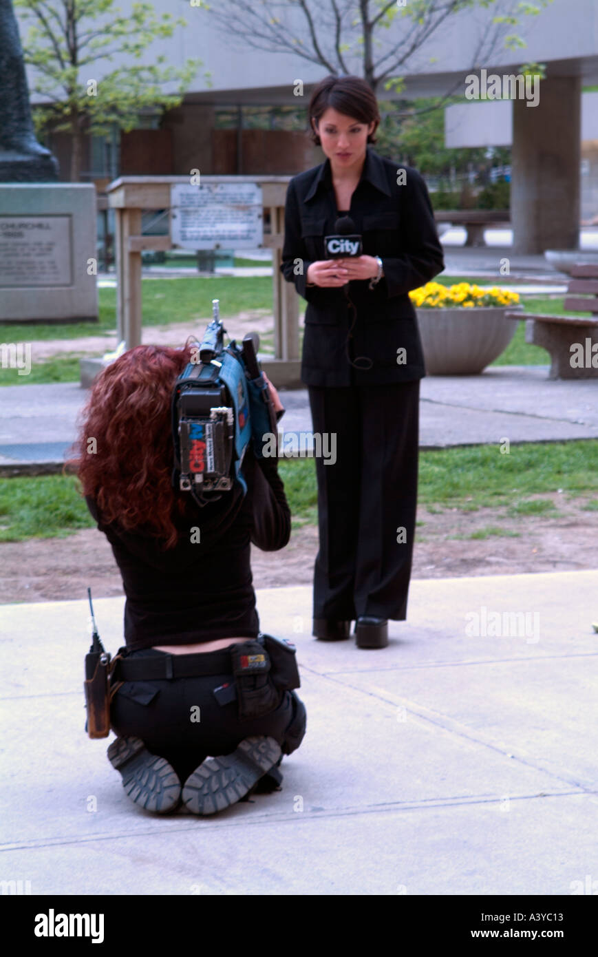 Reportage camera person female reporter taping downtown Toronto Canada ...