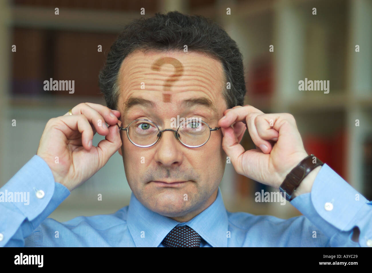 MR Man in the office with queston mark on his forehead looking ...