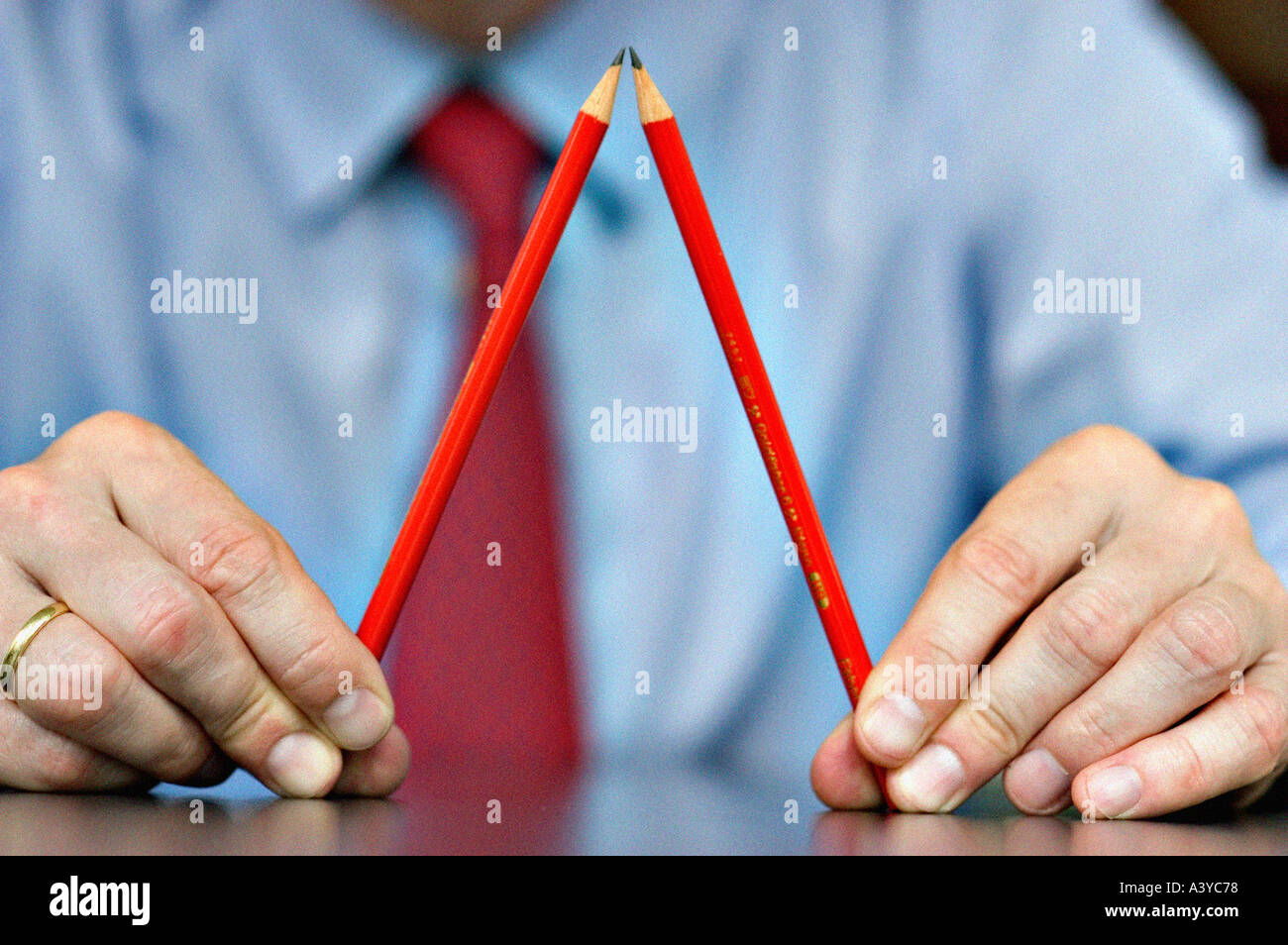 MR Symbol for planning and exactness man holding pencils together Stock ...