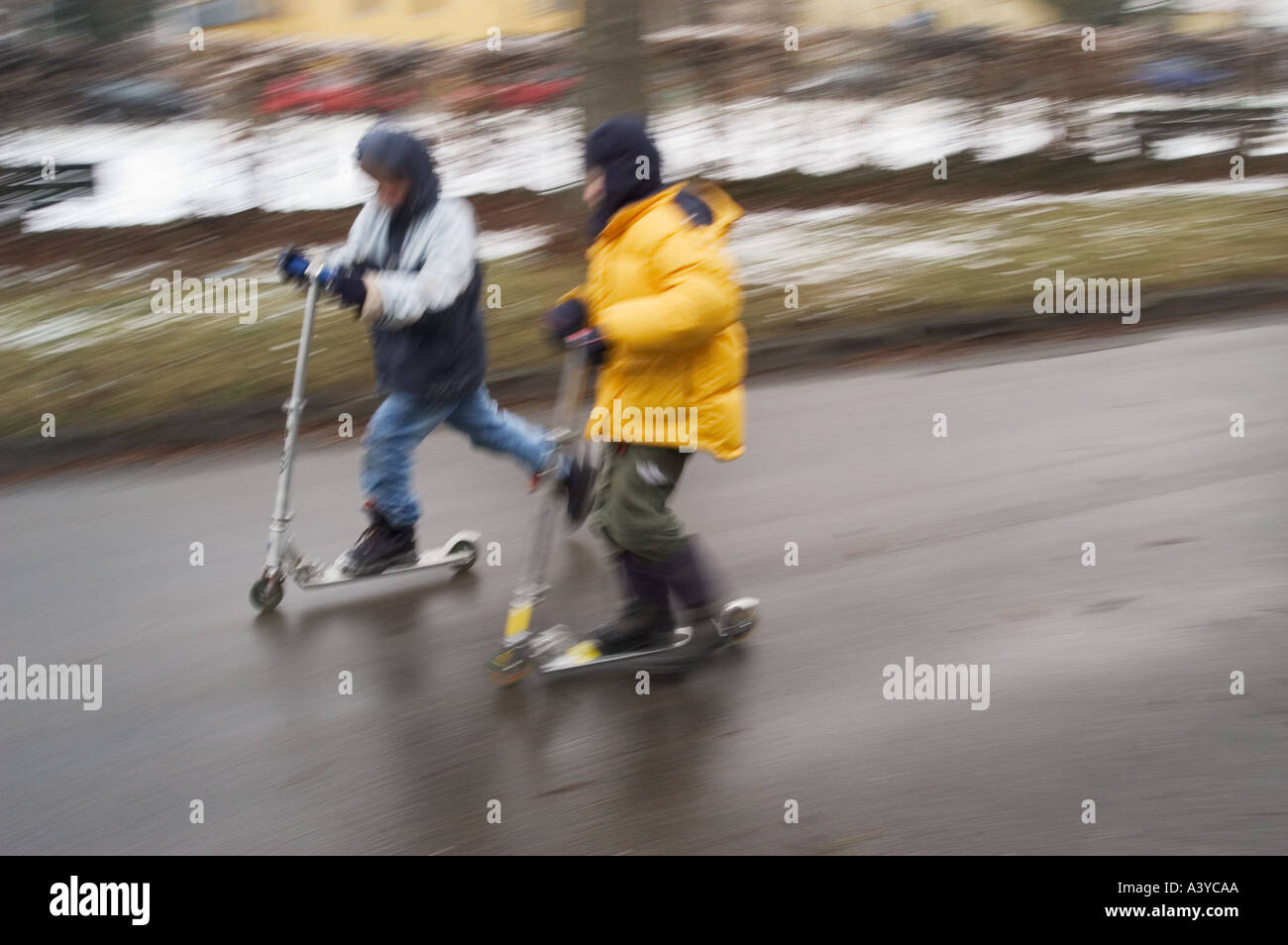 MR Two boys on scooters in winter Stock Photo - Alamy