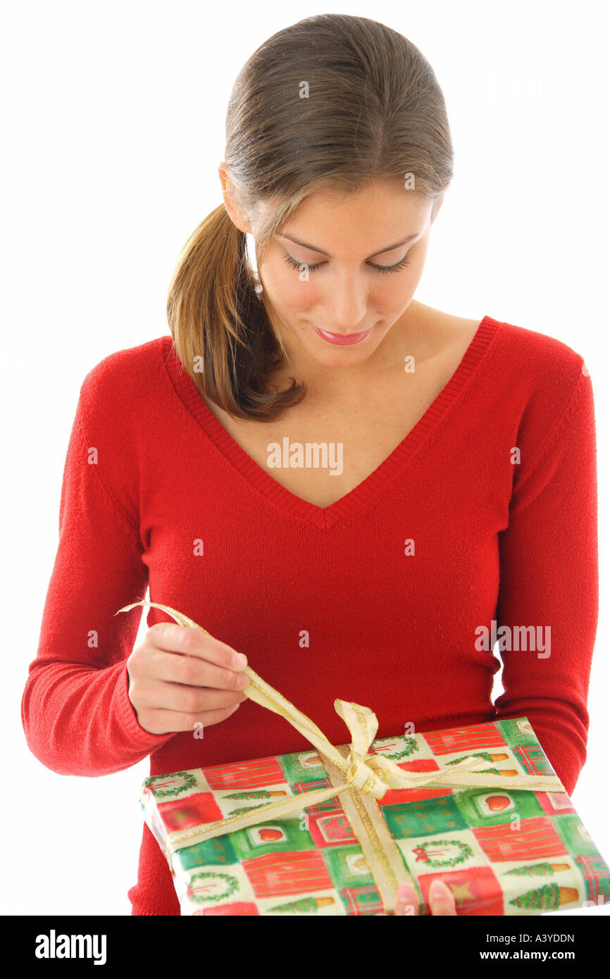 young woman opening a Christmas present Stock Photo - Alamy