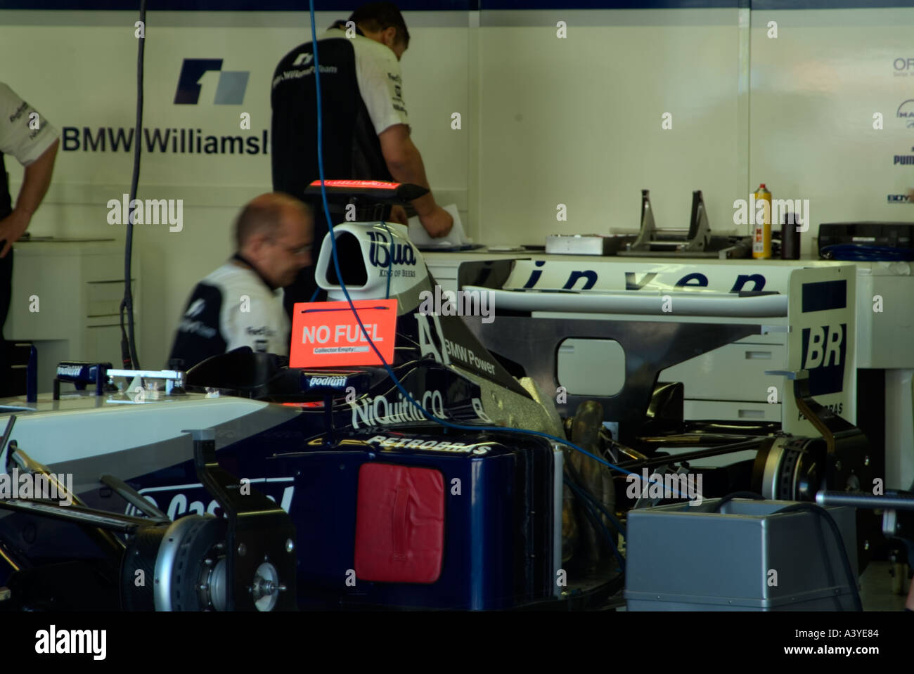 Formula 1 racing car pit lane inside garage mechanics working Gilles ...