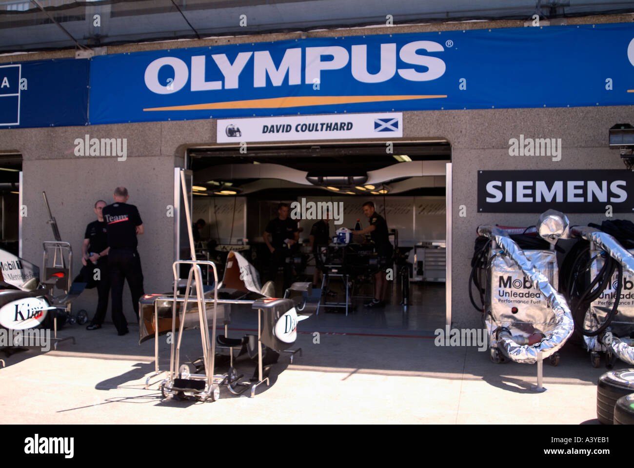 Formula 1 racing car pit lane inside garage mechanics working Gilles ...