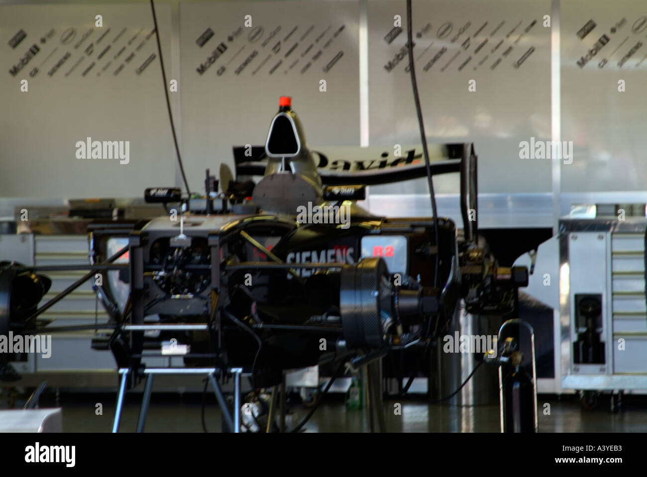 Formula 1 racing car pit lane inside garage mechanics working Gilles ...
