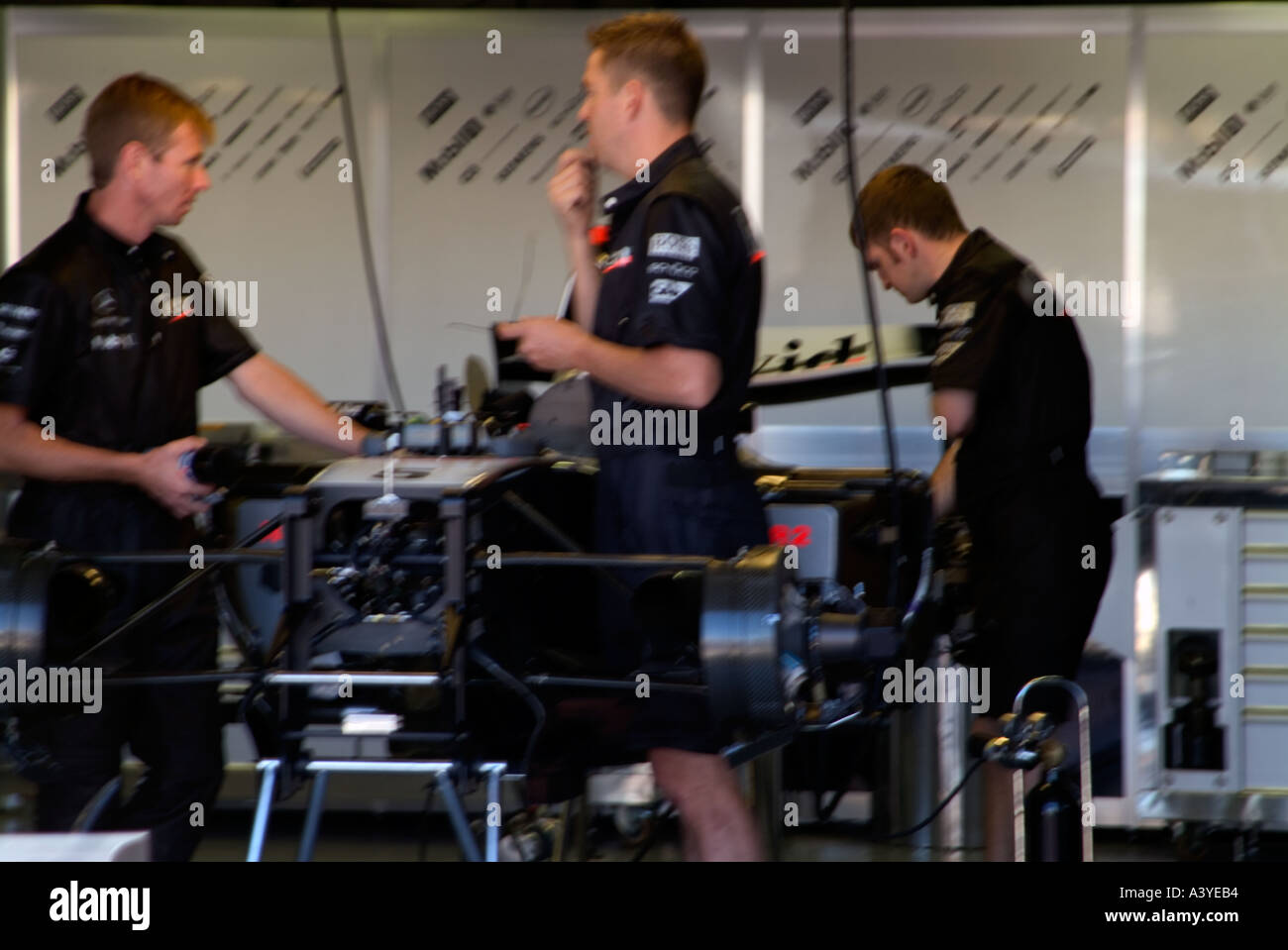 Formula 1 racing car pit lane inside garage mechanics working Gilles ...