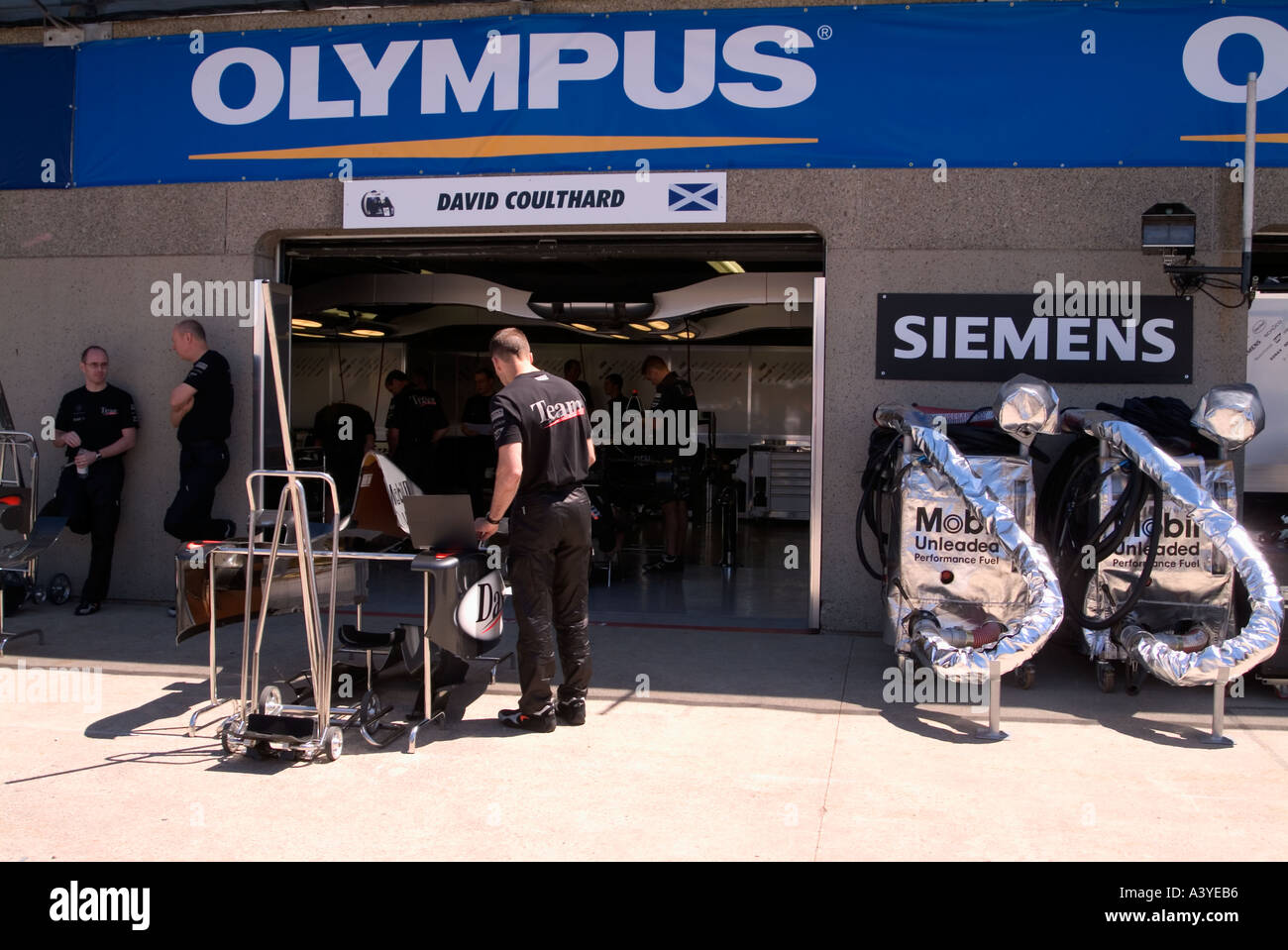 Formula 1 racing car pit lane inside garage mechanics working Gilles ...