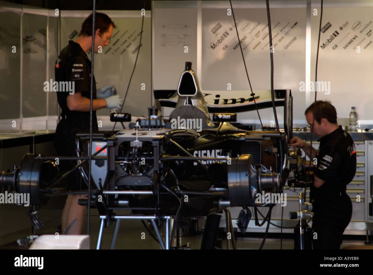 Formula 1 racing car pit lane inside garage mechanics working Gilles ...