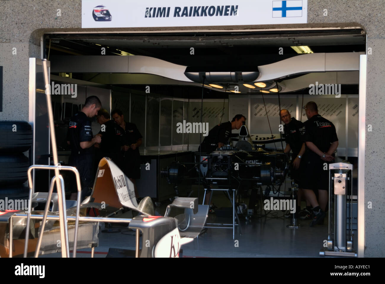 Formula 1 racing car pit lane inside garage mechanics working Gilles ...
