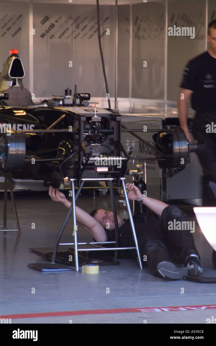Formula 1 racing car pit lane inside garage mechanics working Gilles ...