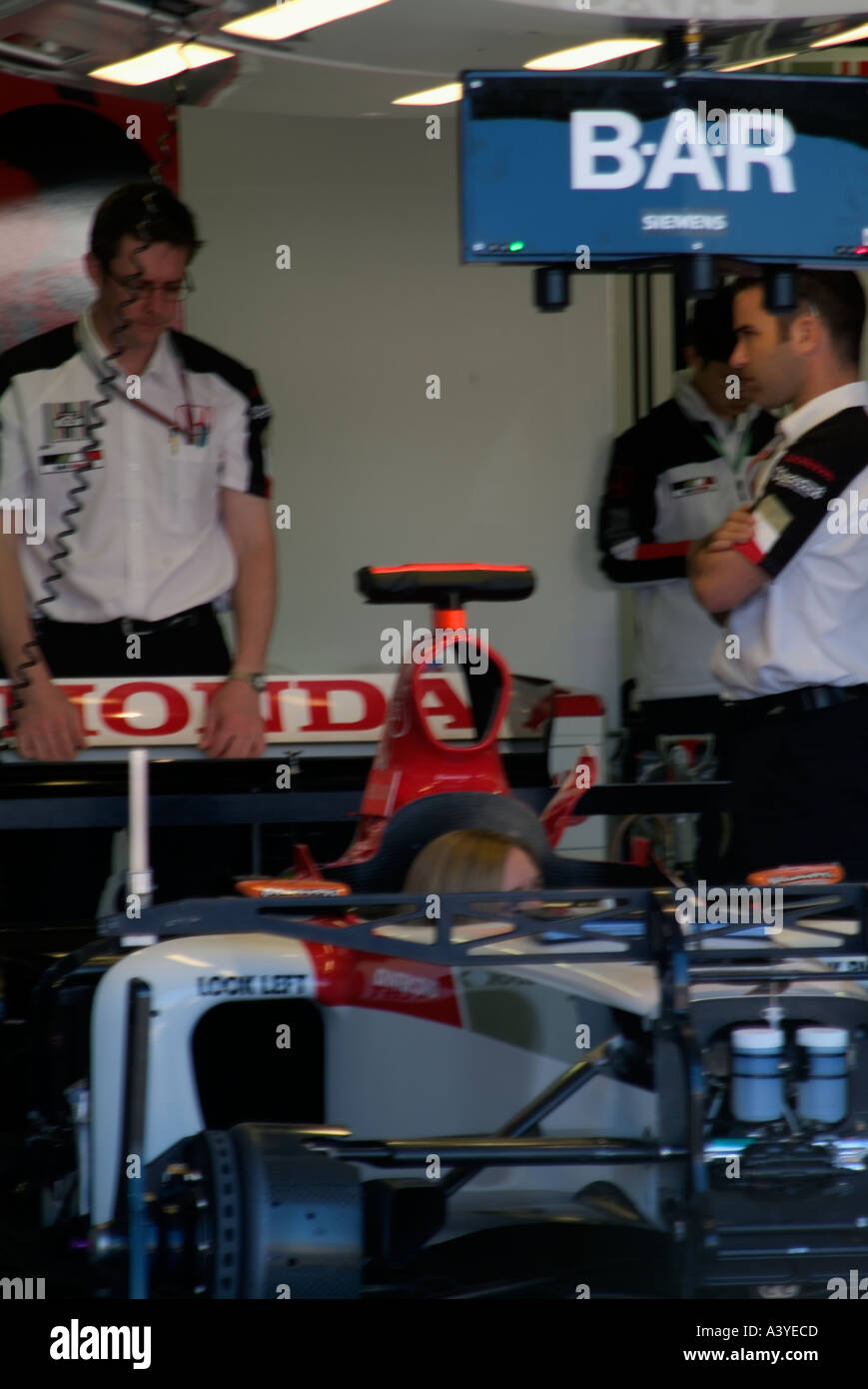 Formula 1 racing car pit lane inside garage mechanics working Gilles ...