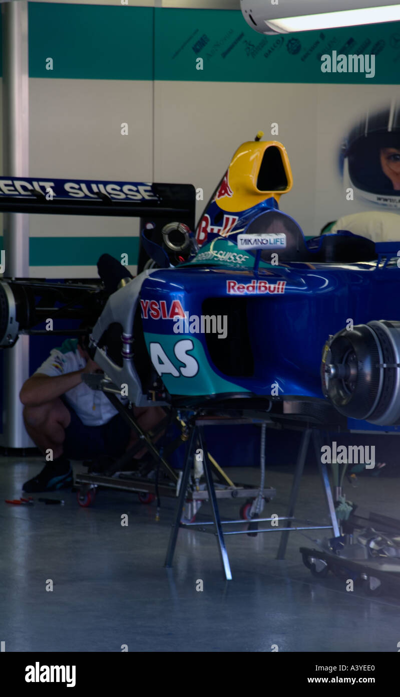 Formula 1 racing car pit lane inside garage mechanics working Gilles ...
