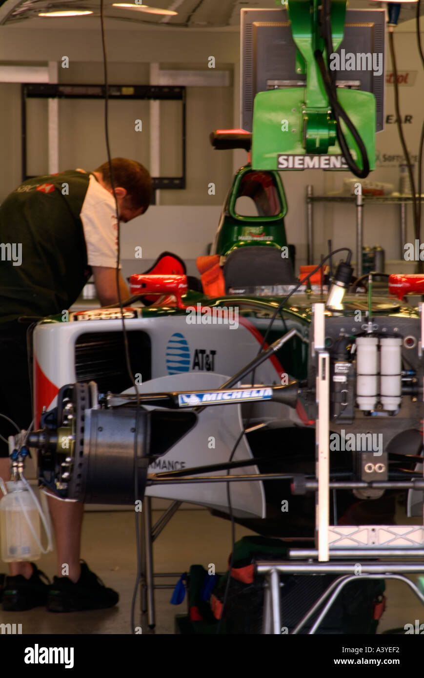 Formula 1 racing car pit lane inside garage mechanics working Gilles ...