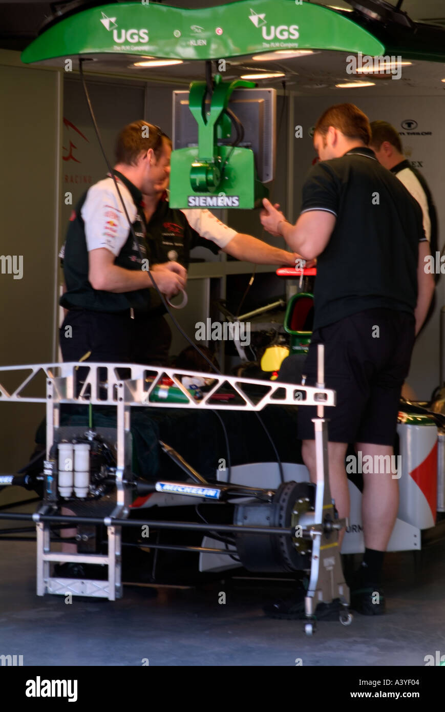Formula 1 racing car pit lane inside garage mechanics working Gilles ...