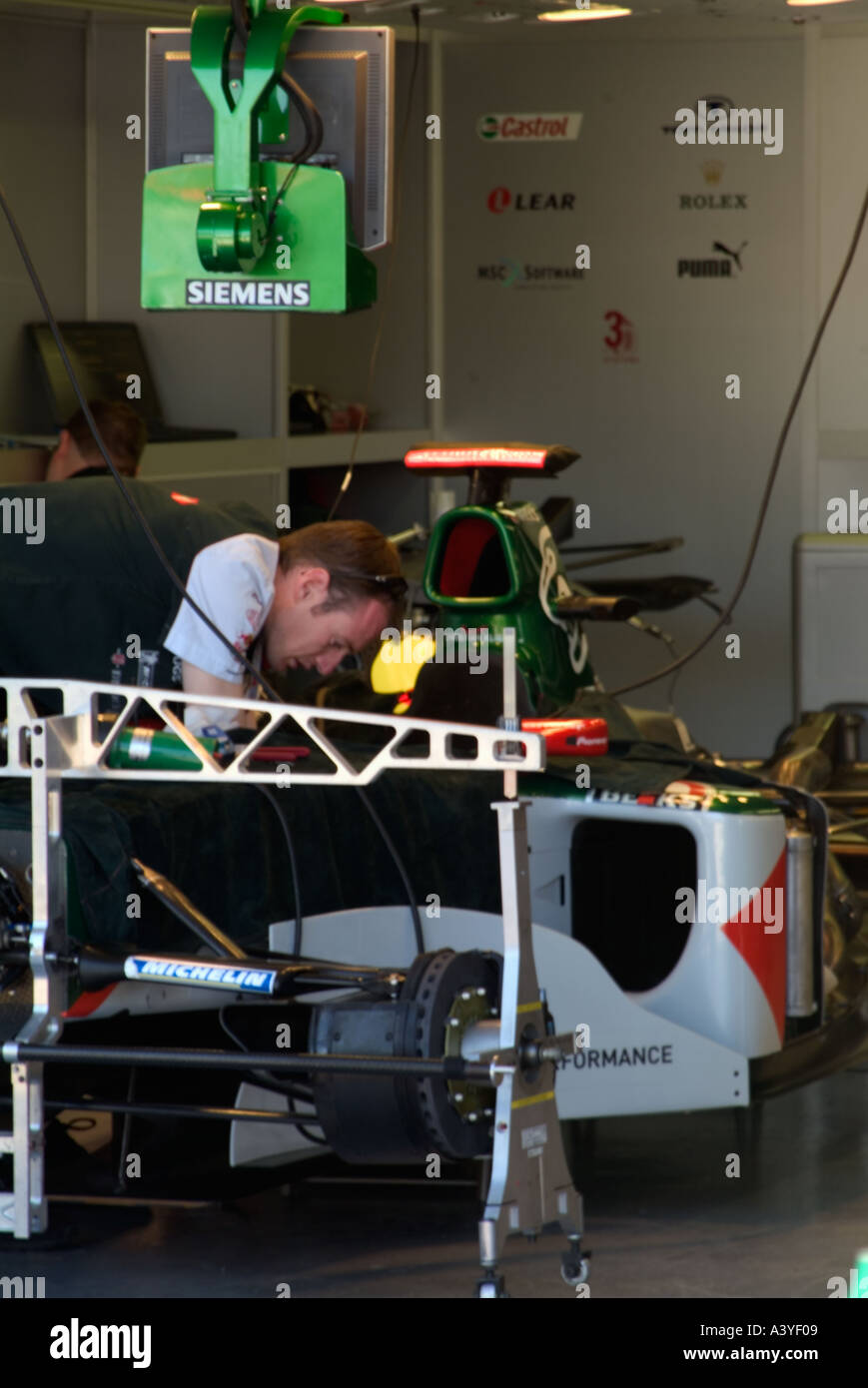 Formula 1 racing car pit lane inside garage mechanics working Gilles ...