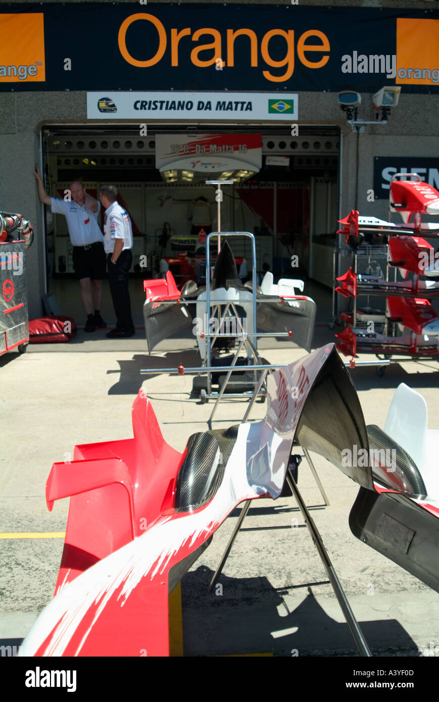 Formula 1 racing car pit lane inside garage mechanics working Gilles ...