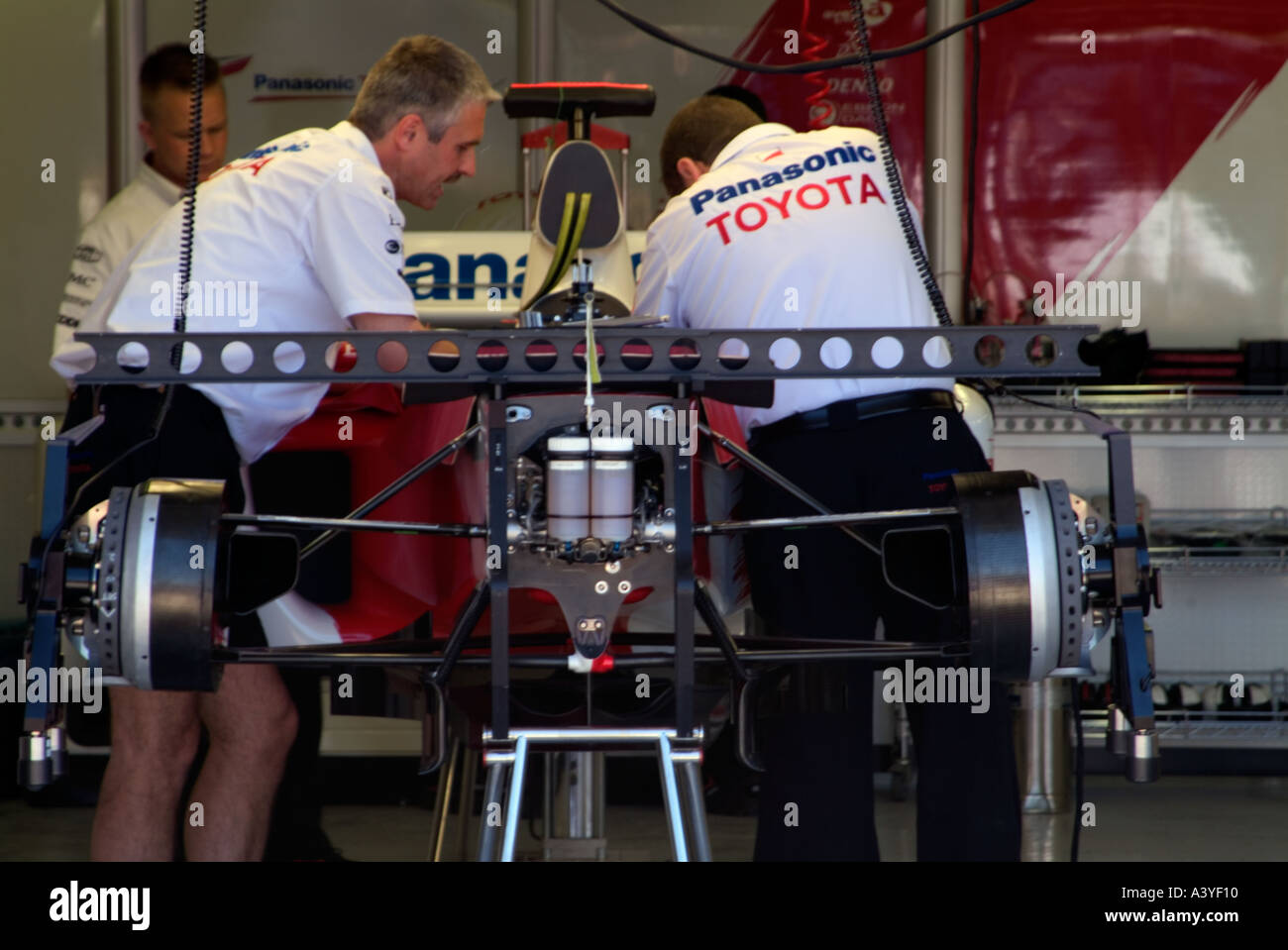 Formula 1 racing car pit lane inside garage mechanics working Gilles ...