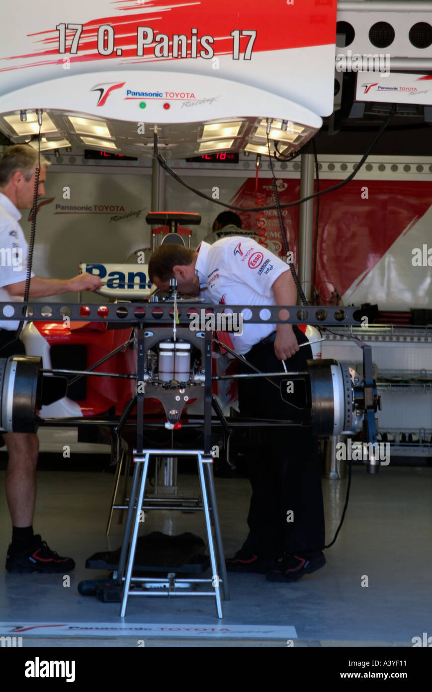 Formula 1 racing car pit lane inside garage mechanics working Gilles ...