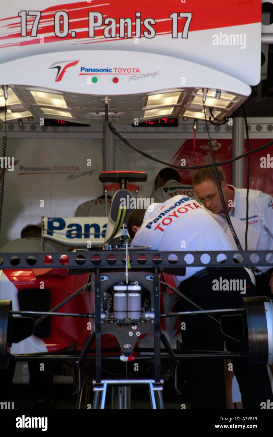 Formula 1 racing car pit lane inside garage mechanics working Gilles ...