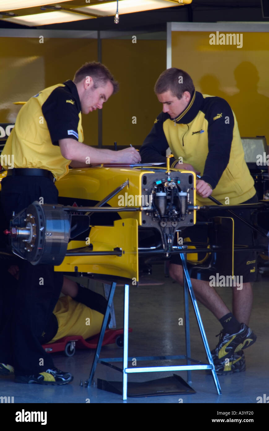 Formula 1 racing car pit lane inside garage mechanics working Gilles ...