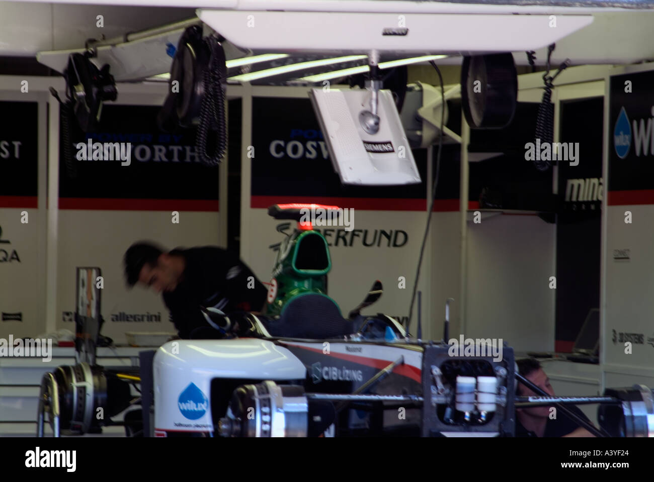 Formula 1 racing car pit lane inside garage mechanics working Gilles ...
