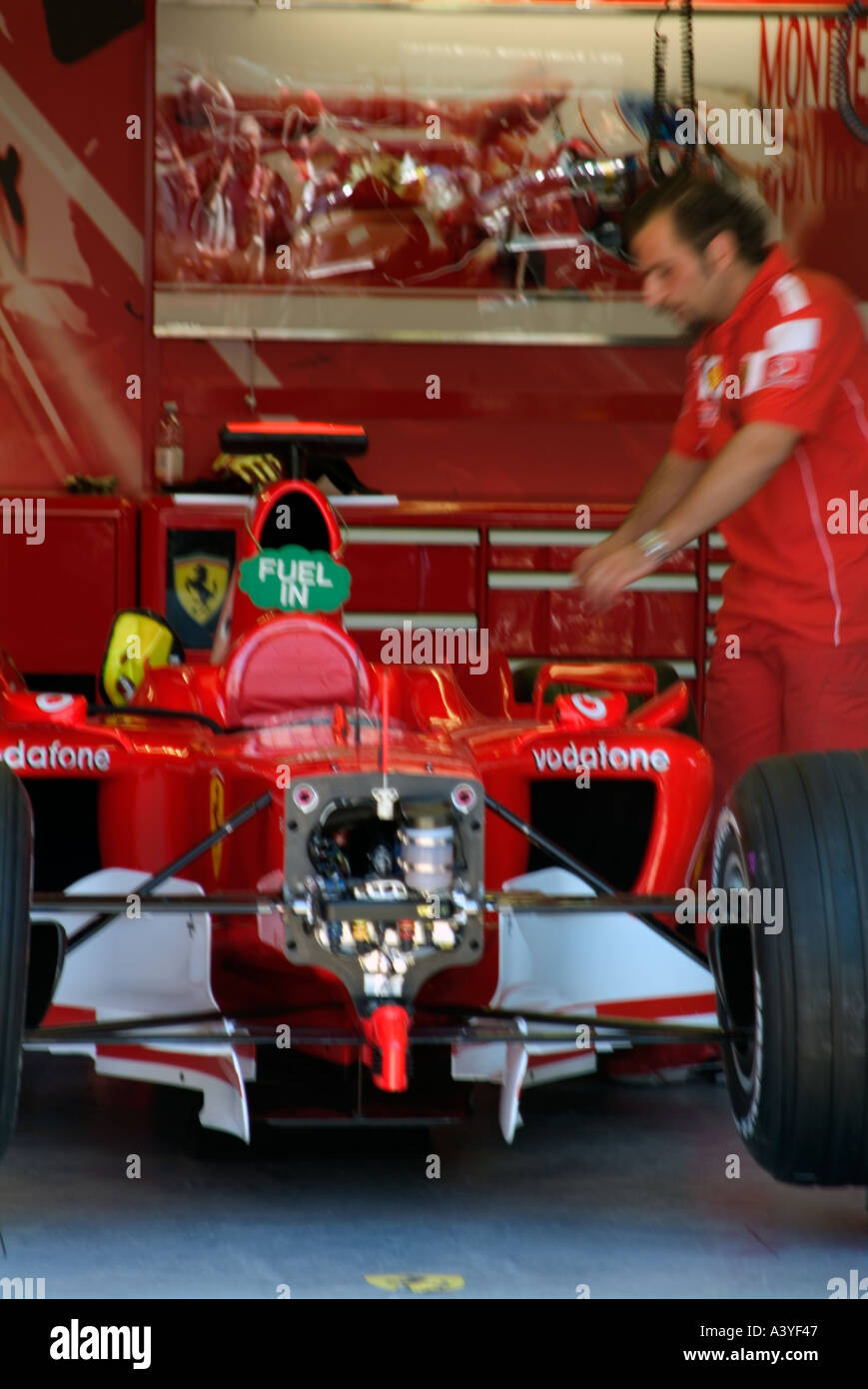 Formula 1 racing car pit lane inside garage mechanics working Gilles ...