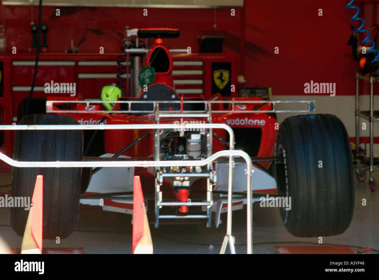 Formula 1 racing car pit lane inside garage rear body view Gilles ...