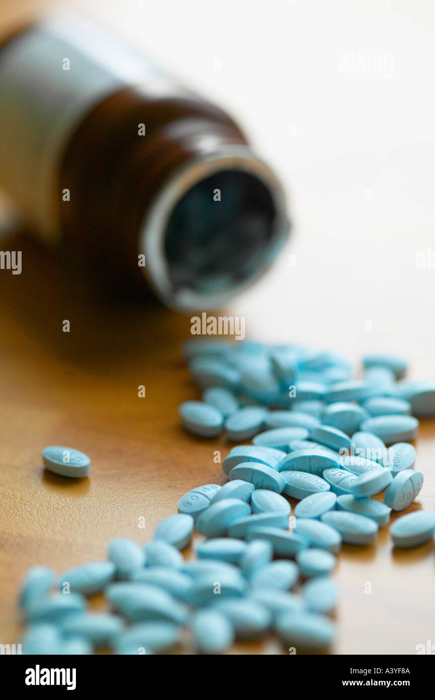little blue pills tablets medication Stock Photo - Alamy