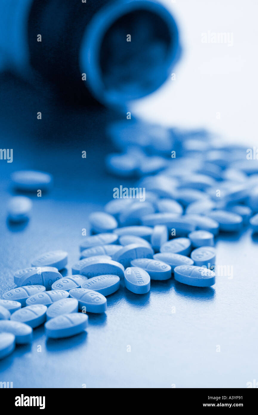 little blue pills tablets medication Stock Photo - Alamy
