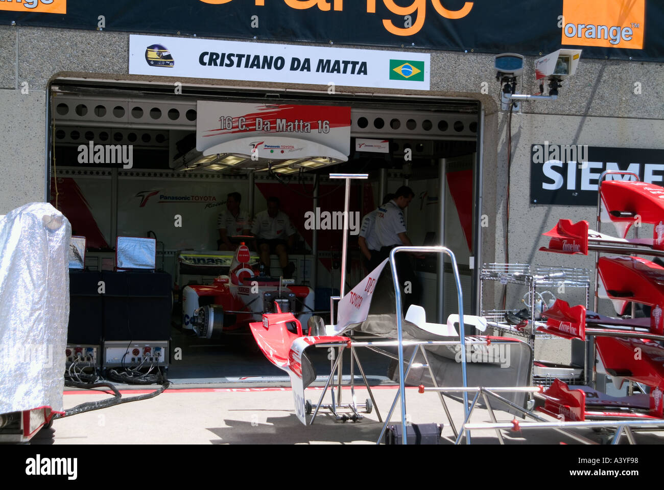 Formula 1 racing car pit lane inside garage mechanics working Gilles ...