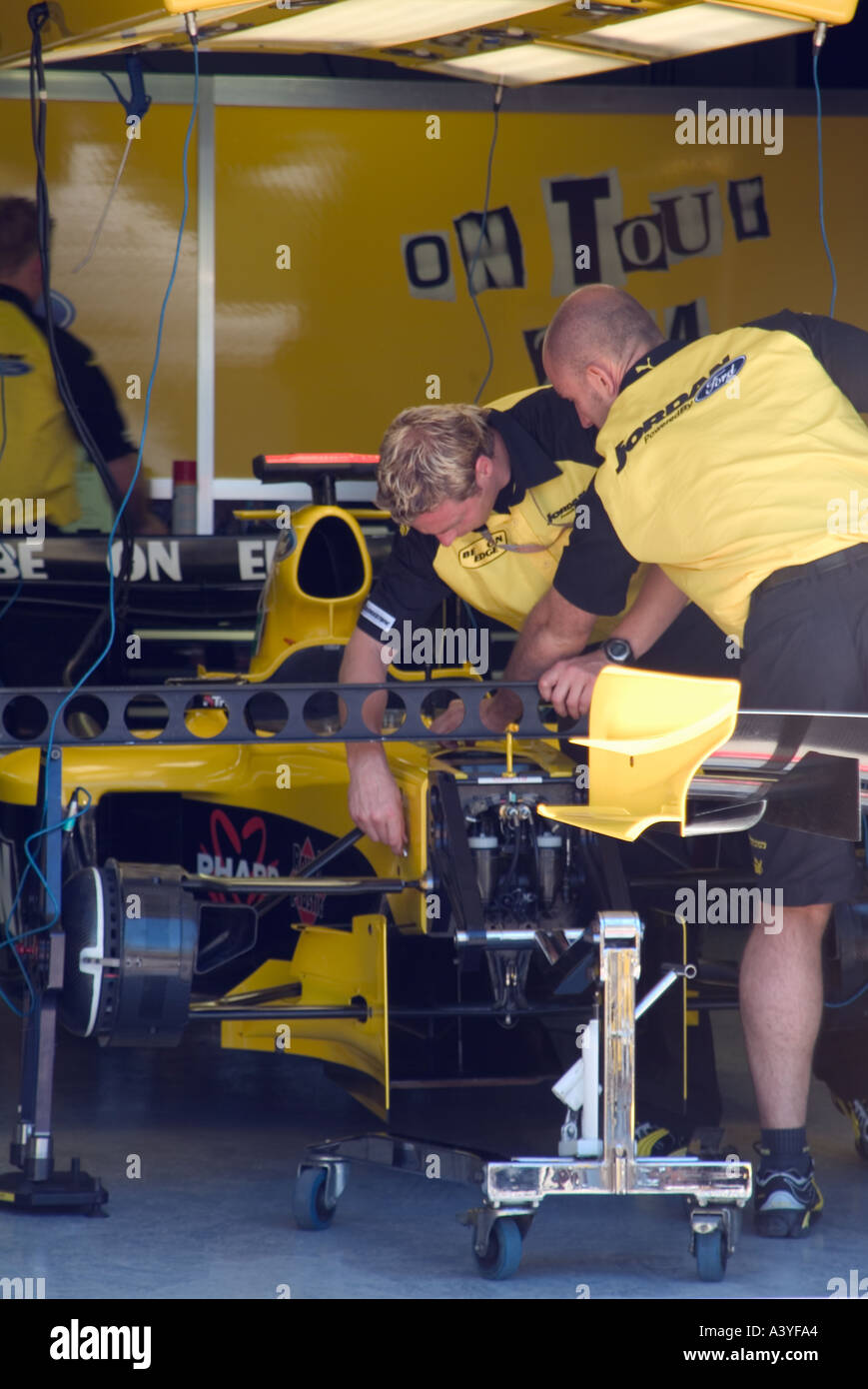 Formula 1 racing car pit lane inside garage mechanics working Gilles ...