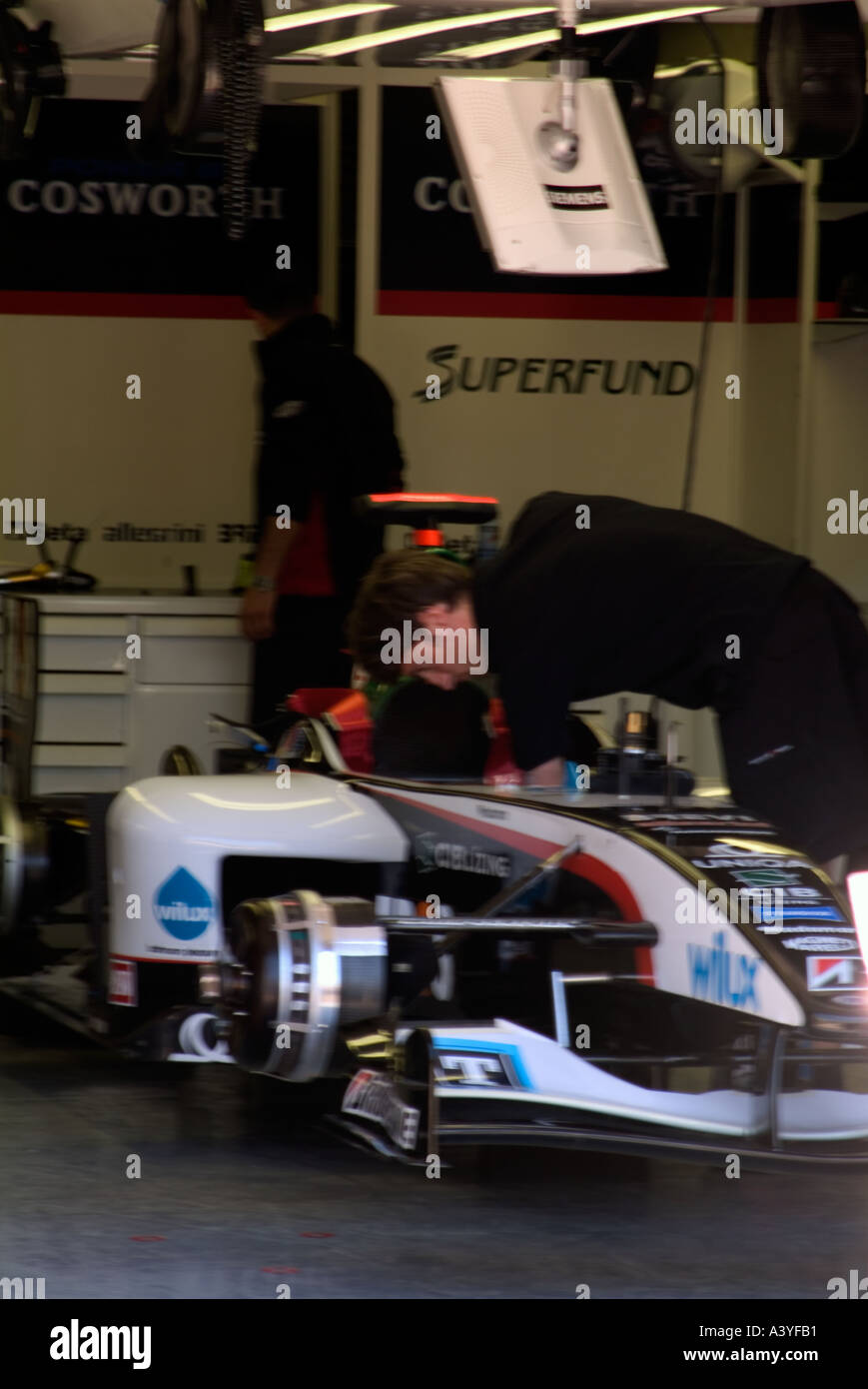Formula 1 racing car pit lane inside garage mechanics working Gilles ...