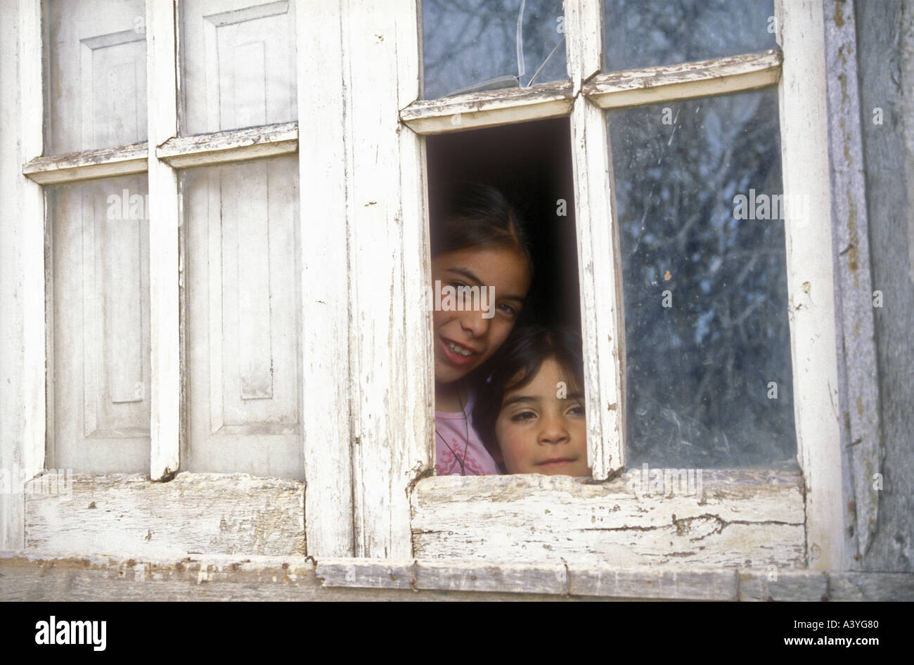 Kids watching throughout the window Stock Photo - Alamy