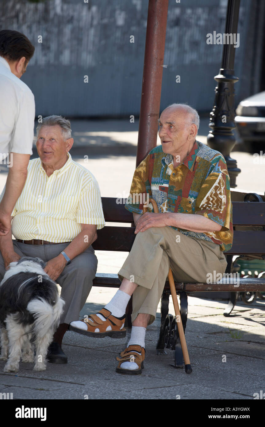 Three old friends talking in a town square in Poland Stock Photo - Alamy