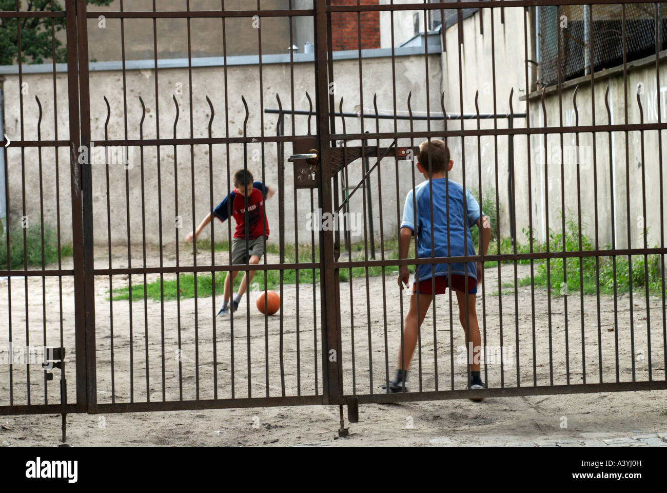 Two boys playing football in the yard of their house Stock Photo - Alamy