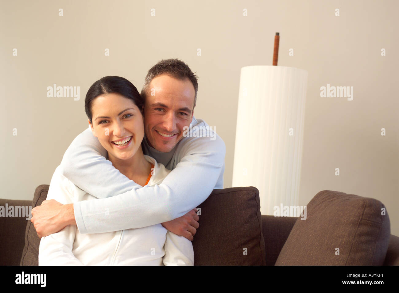 portrait of couple man hugging woman from behind Stock Photo - Alamy
