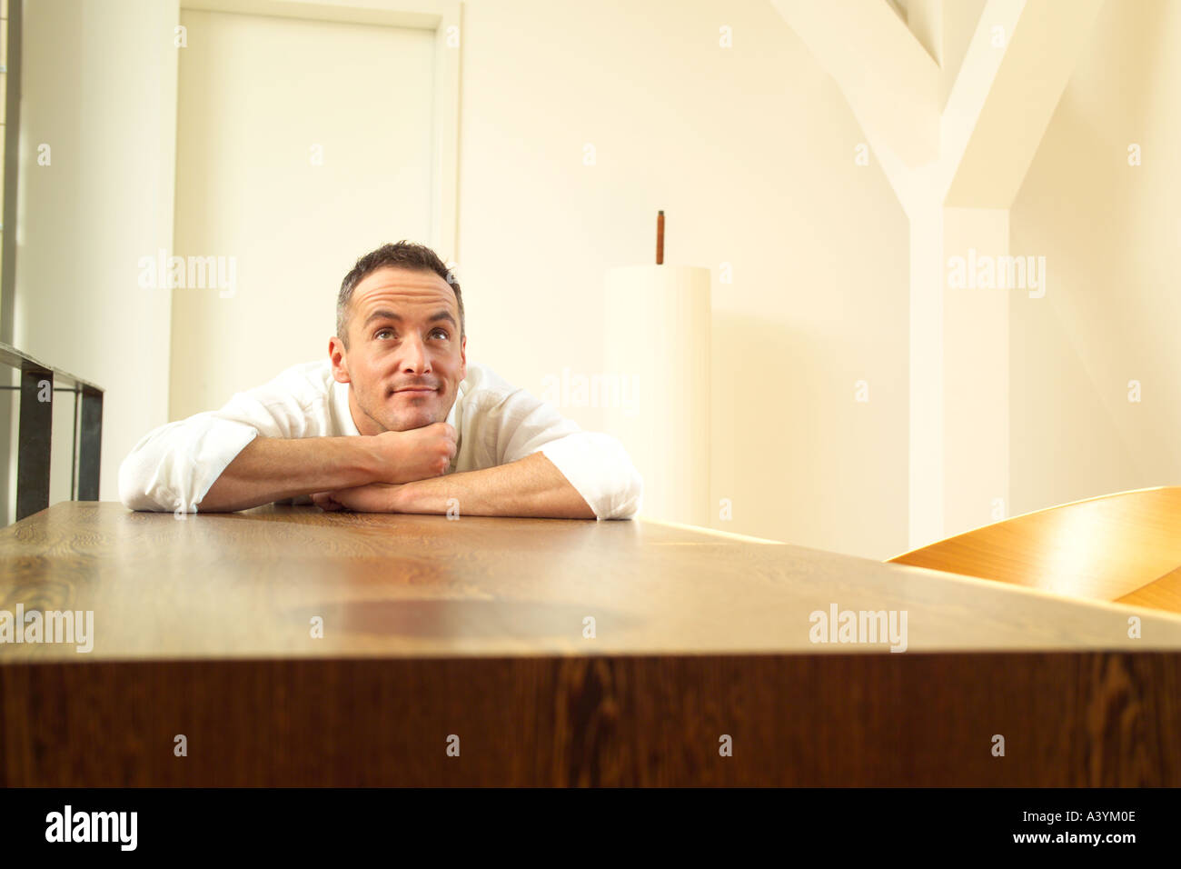Man resting his one arm on table hi-res stock photography and images ...