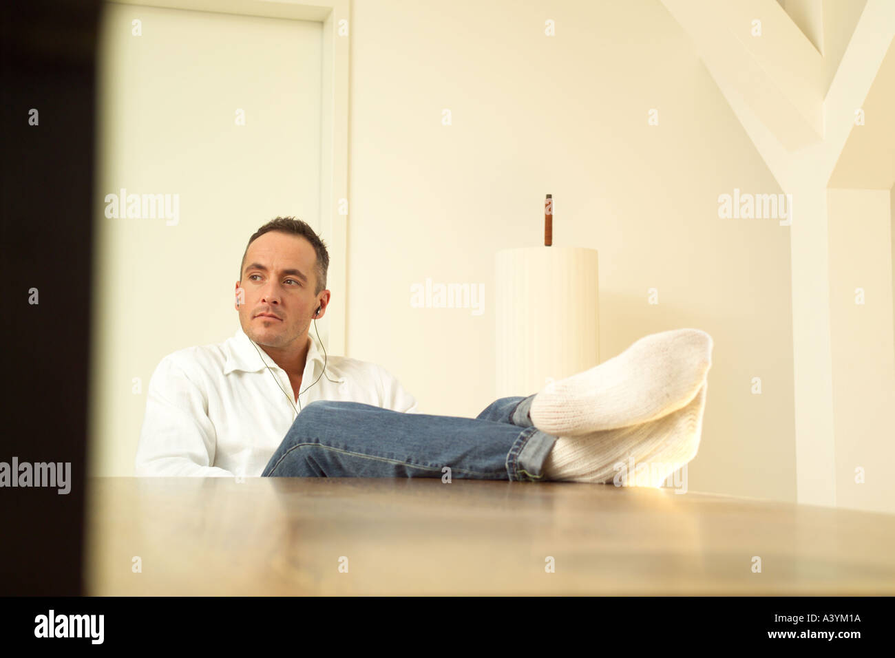 young man with feet on the table Stock Photo - Alamy