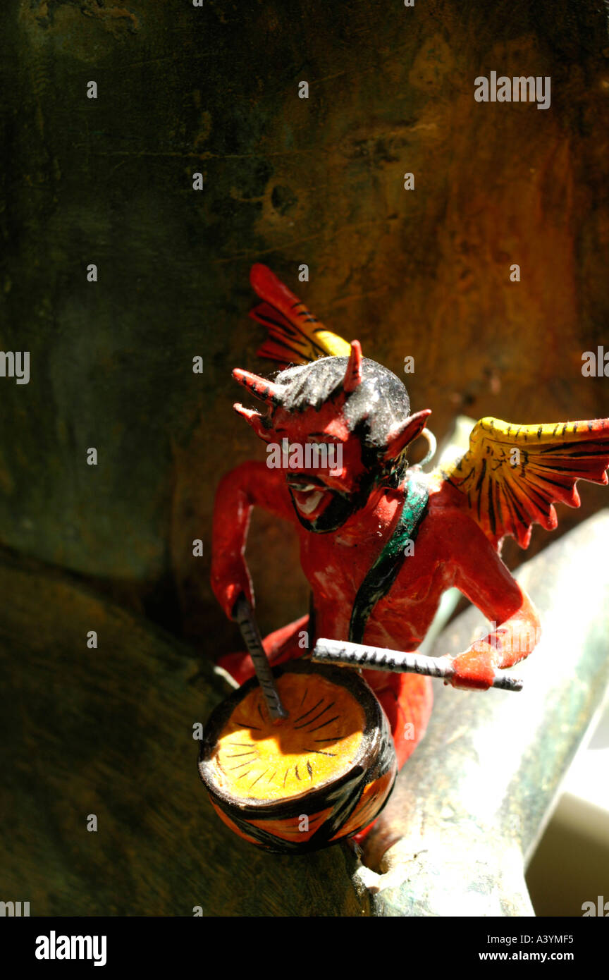 Devil figure playing a drum with wings on his back and a beard Stock ...